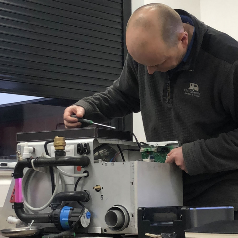 working-on-boiler | Caravan Service & Repair